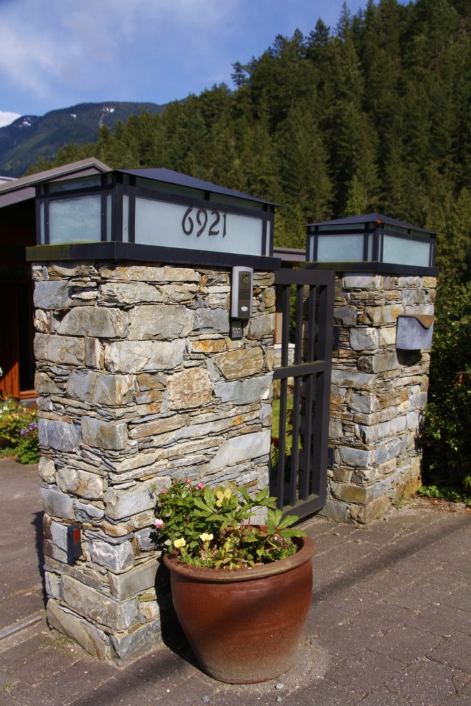 Metal Gate Entry with Natural Stone Pillars